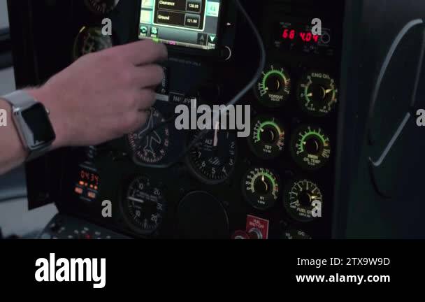 CLOSE UP: A helicopter pilot manipulates the helicopter flight controls ...