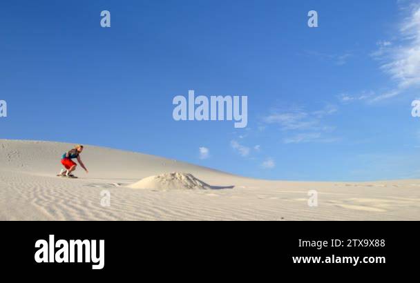 Man performing a jump while sand boarding in the desert 4k Stock Video ...