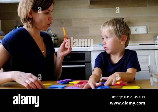 Mother with preschool boy learning english alphabet and numbers Stock ...