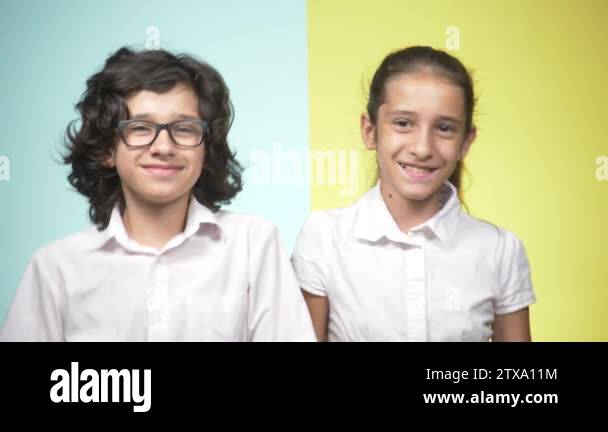Portraits of children in school uniform on a colored background. Funny ...