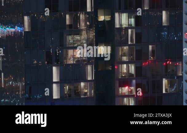 Night view of exterior apartment tower. High rise skyscraper with ...