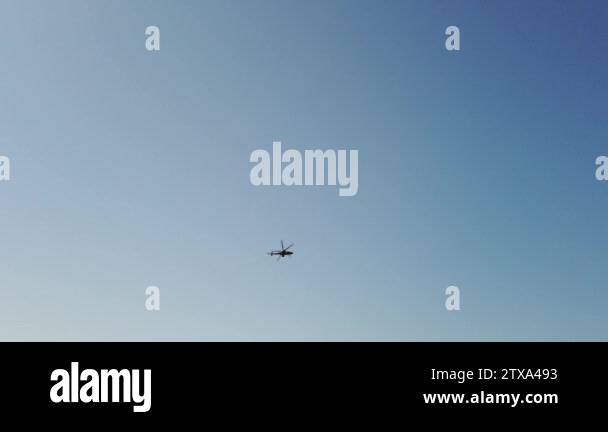 Military helicopter on battlefield flies overhead passing in slow ...