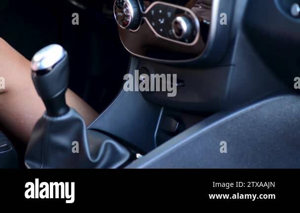 Starting and stopping the engine of a car. The womans hand inserts the ...