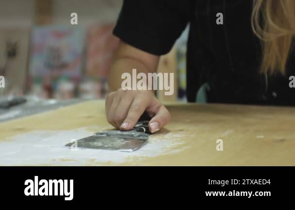 Masters in the art studio process the wood with paint and putty ...