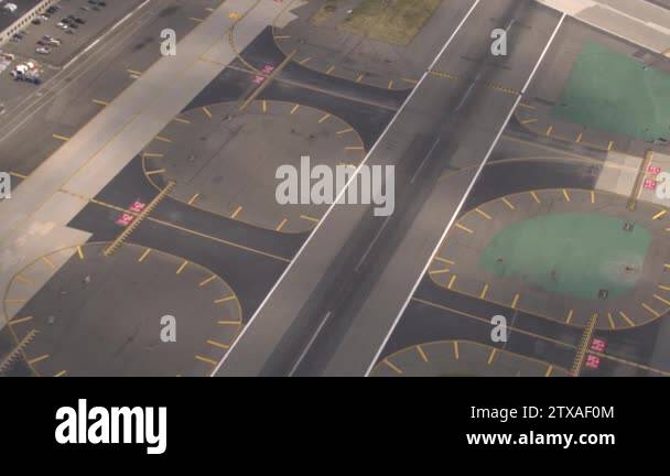AERIAL, CLOSE UP: Flying close above large asphalt and concrete piste ...