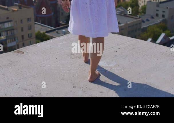 Reckless woman steps towards edge of building, fear of height suicide ...