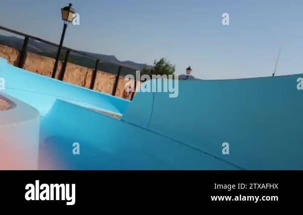 Falling down the slide and diving in a water park in summer holiday ...