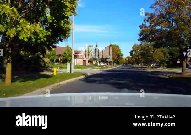 Rear View From Back of Car Driving Around Road Bend in Residential ...