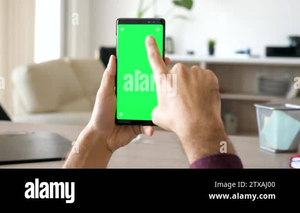 Man hand scrolling down and right on a modern smartphone with green ...