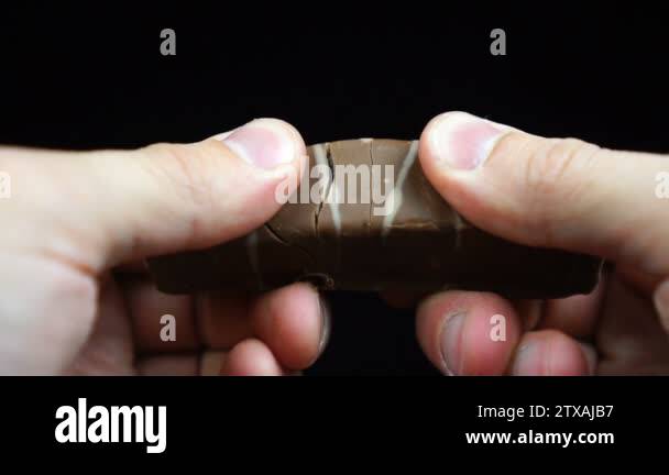 Hands break a bar of chocolate. Snapping chocolate in half Stock Video ...