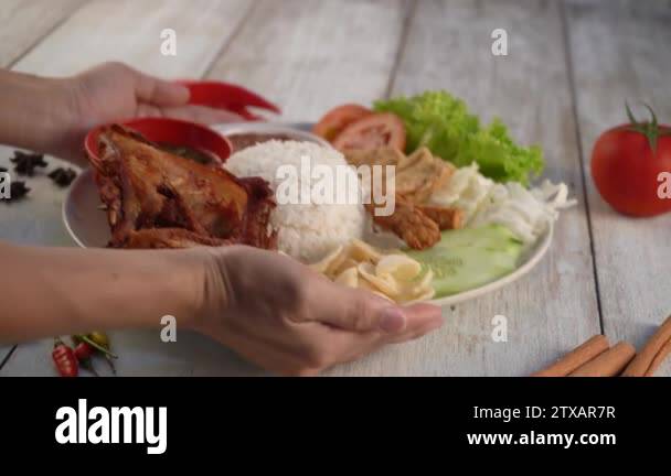 nasi kukus, traditional malay steamed rice with tumeric fried chickens ...