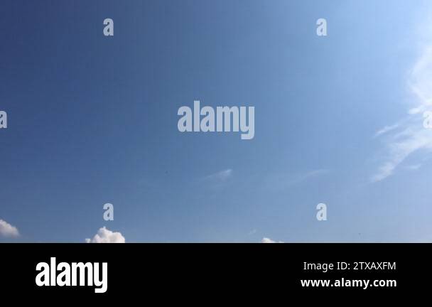 White clouds disappear in the hot sun on blue sky. Loop features time ...