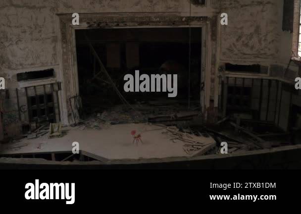 Lonely chair standing in the middle of the stage in creepy decaying ...