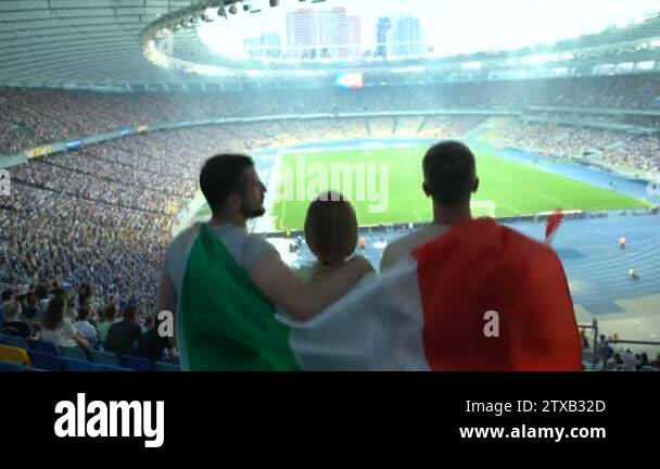 Football fans with Italian flag jumping at stadium, cheering for ...