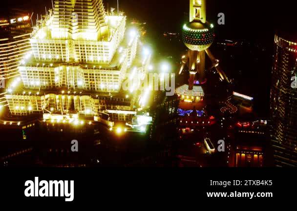 Elevated view of high-rise buildings rooftop crown with river at night ...