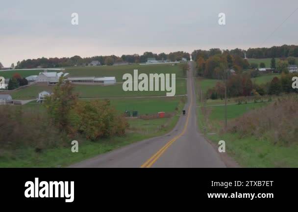 CLOSE UP: Traditional Amish family traveling in horse-drawn buggy ...
