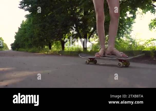 Crop legs riding skateboard in countryside Stock Video Footage - Alamy