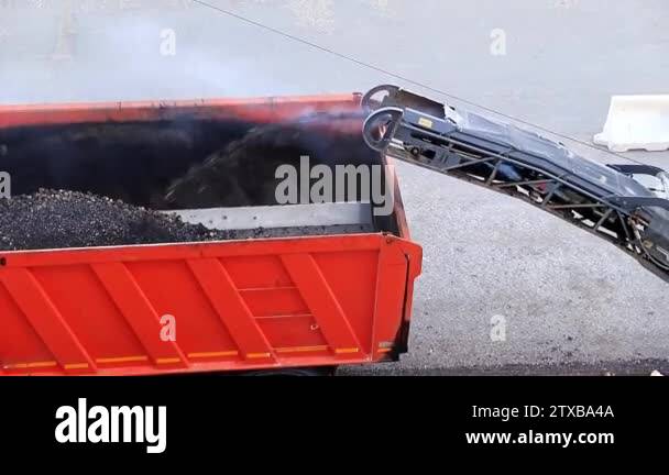 the work of road machinery when repairing a highway, the loading of cut ...