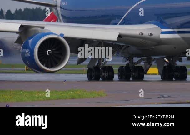 Undercarriage and engine of Jambo Jet airplane moving on taxiway ...