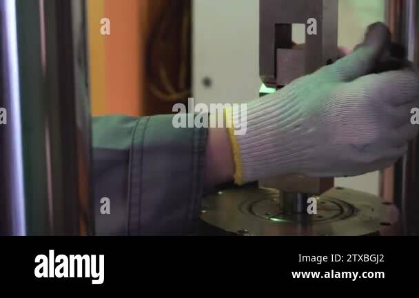 Metal sample is tested for compressive strength. Footage. Close-up of ...
