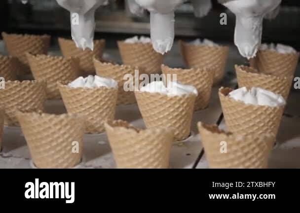 Robot machine Automatically pours ice cream in a Wafer cups. The ...