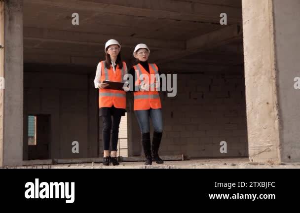 Female architects at a construction site, depending on how the ...