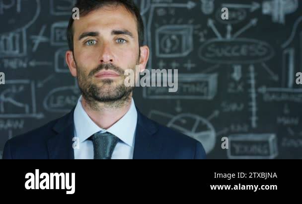 Portrait of a business man, a marketing teacher, draws a graph of ...