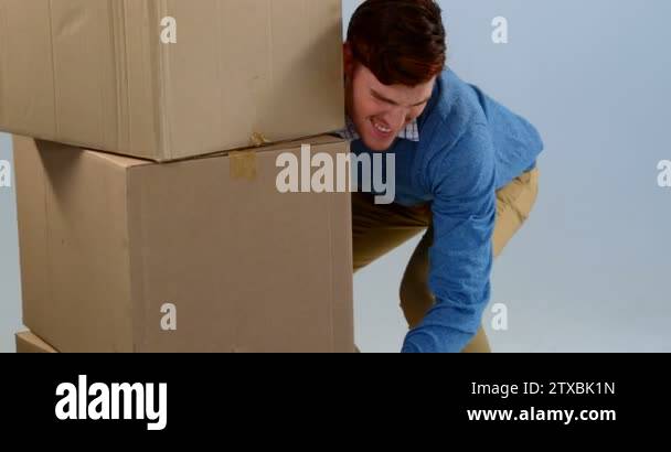 Courier man picking up cardboard boxes blue background 4k Stock Video ...