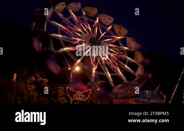 The roundabout quickly turns in amusement park and burns with multi ...