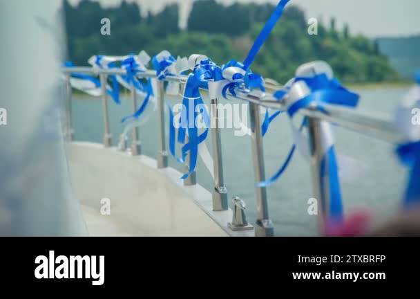 White-and-blue ribbons are tied to the protection fence of the yacht ...