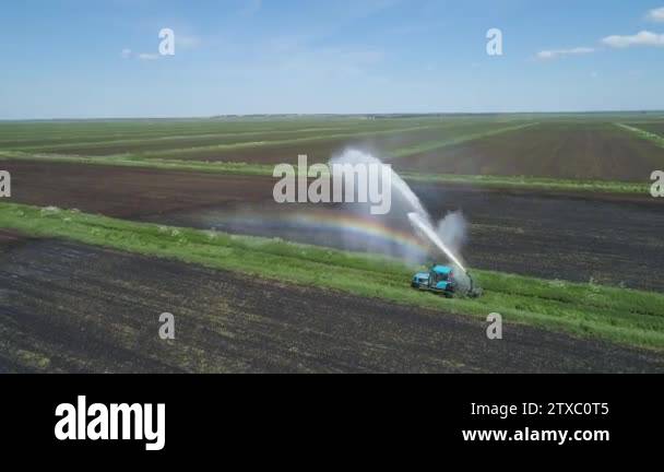 Irrigation system on agricultural land. A large stream of water to ...