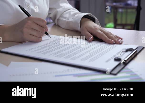 close up details unrecognizable businesswoman holding contract and sign ...