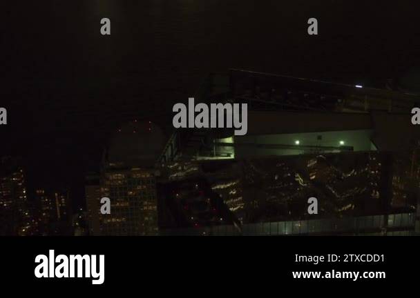 AERIAL HELI SHOT, CLOSE UP: Flying above the rooftop of Four World ...