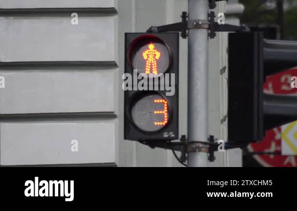 Pedestrian crossing lights turn from red stop to green walk. Lights on ...