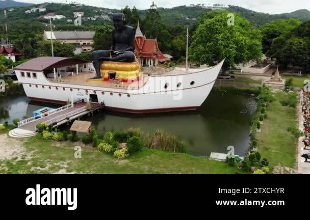Black monk statue on ship in pond. Huge black monk sculpture located in ...