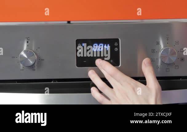 Metallic Toggle Switch of the Cooker Oven. Close-up View. Digital Clock ...