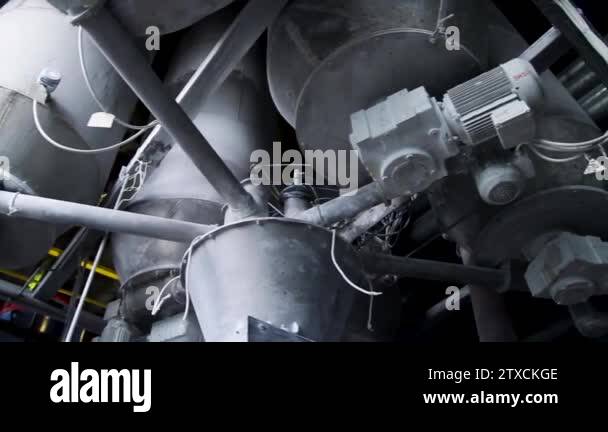 Close-up of pipelines and destillation tanks of an oil-refinery plant ...