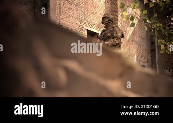 Shooting from the down corner, caucasian soldier is standing still and ...