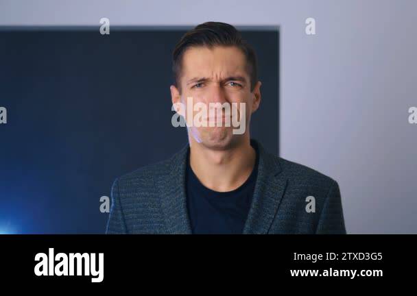 Portrait of attractive man making facepalming pose with hand. Showing ...