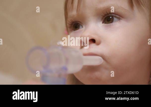 child is sick and breathes through an inhaler. Toddler treats flu by ...