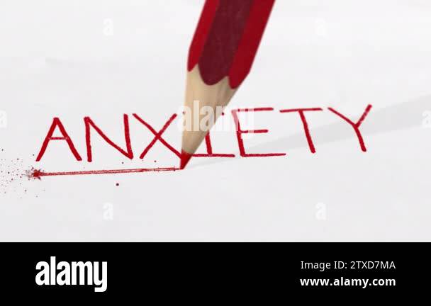 Anxiety word written in red is strongly underlined by a pencil that ...
