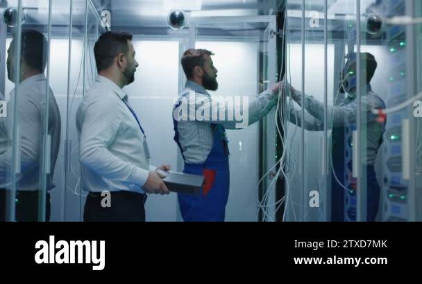 Two men performing maintenance in a data center Stock Video Footage - Alamy