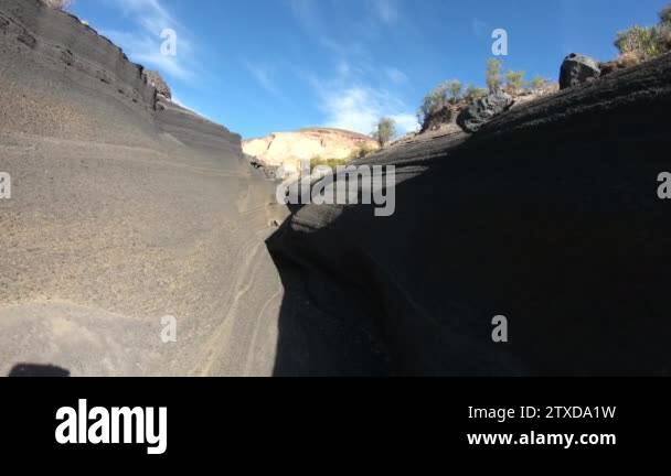 Walking inside volcano malacara grey debris, dry river of vocanic ...