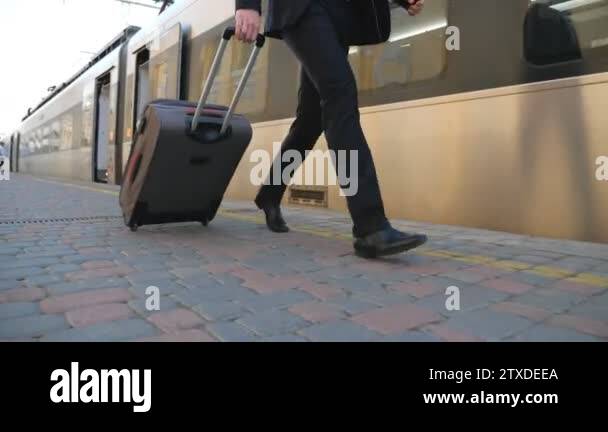 Legs of successful businessman in suit walking along platform and ...