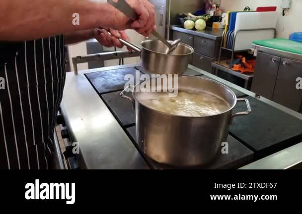 skilled cook gathers white foam from boiling dish in pot Stock Video ...