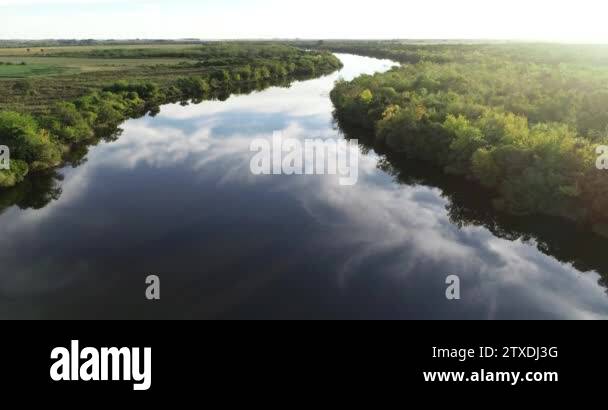 Aerial of river with natural vegetation at riverbends and reflection of ...