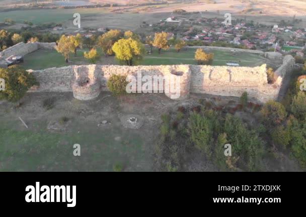 A medieval fortress with preserved walls and watchtowers on top of a ...