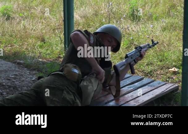 MOSCOW - JULY 30. Soldiers shoot from an AK-47 machine gun at targets ...