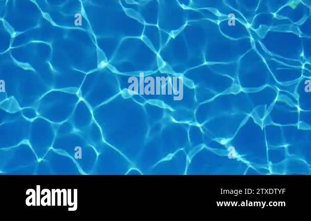 Arty looking swimming pool water shining with its rippling turquoise ...
