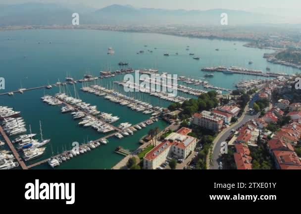 Marina and pier with yachts, seaside town on the beach, hotel and ...